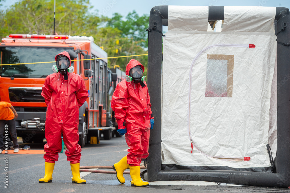 Rescuers wearing red hazmat suits assembled a Inflatable sterilization ...
