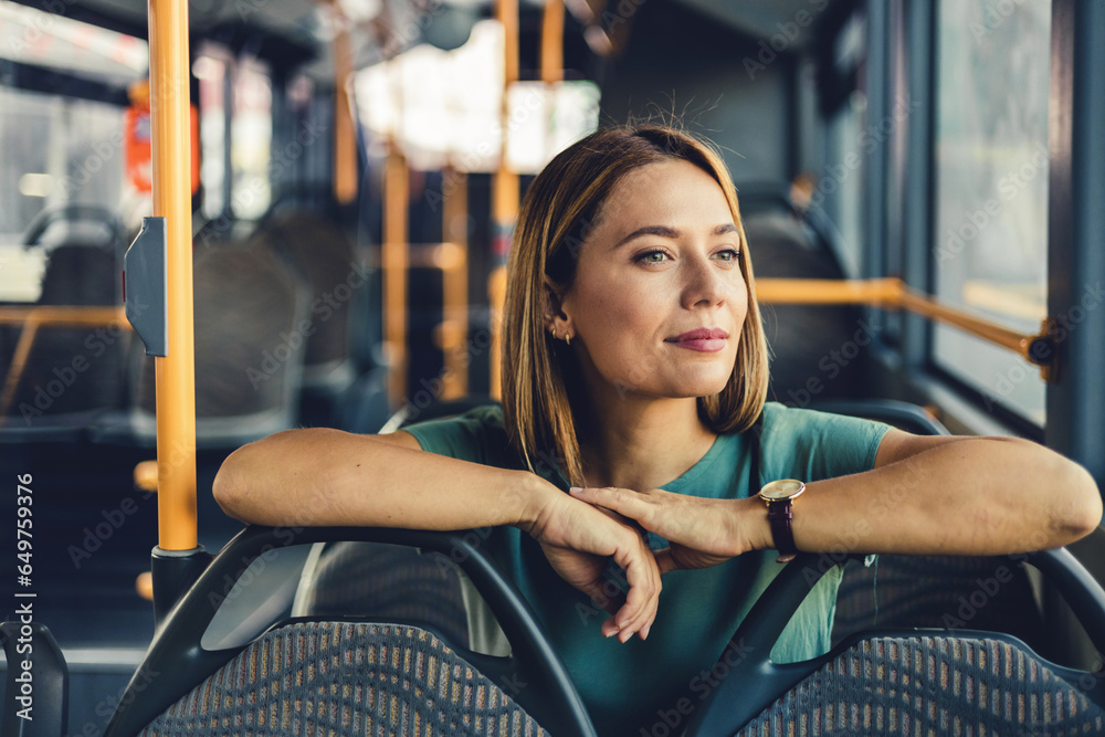 Beautiful woman sitting on the public bus. Woman traveler contemplating ...