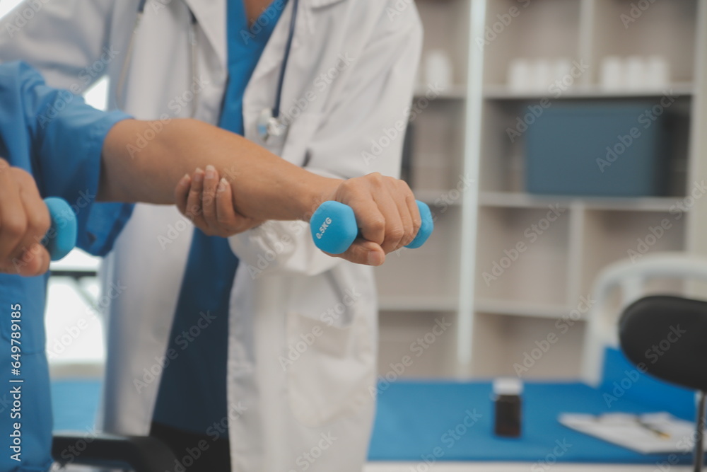 Asian older aged man doing physiotherapist with support from nurse ...