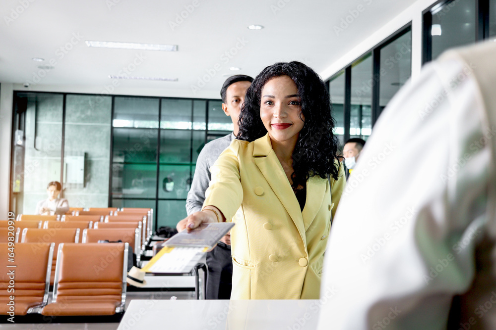 Beautiful female traveler gives passport boarding pass to passenger ...