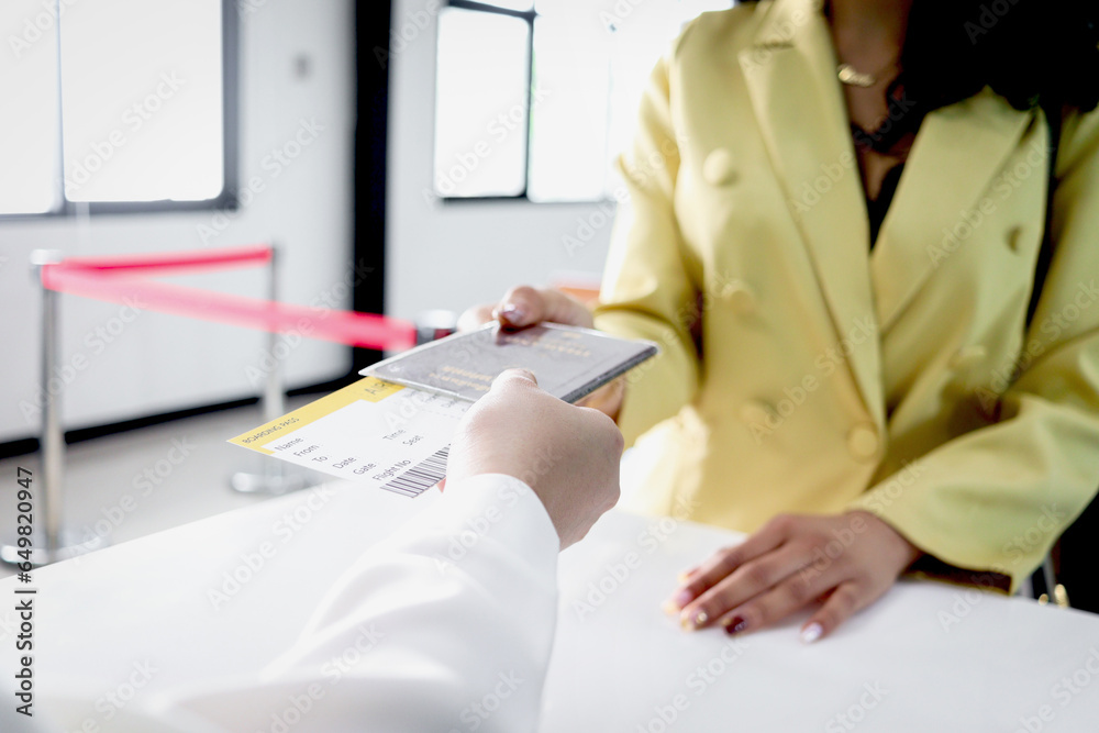 Hand of passenger service agent staff receiving passport and boarding ...