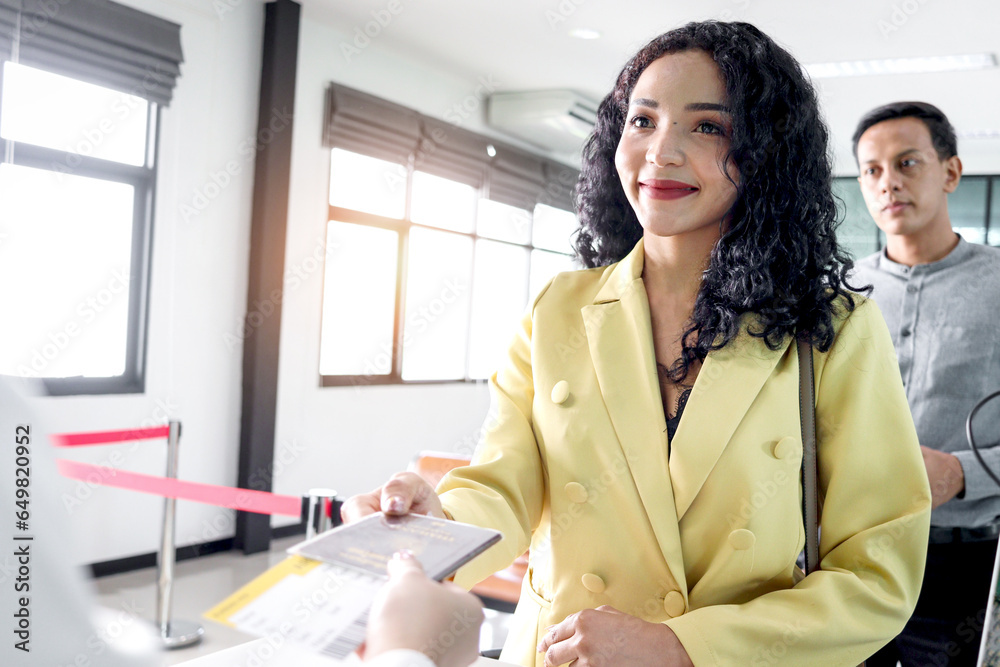 Beautiful female traveler gives passport boarding pass to passenger ...