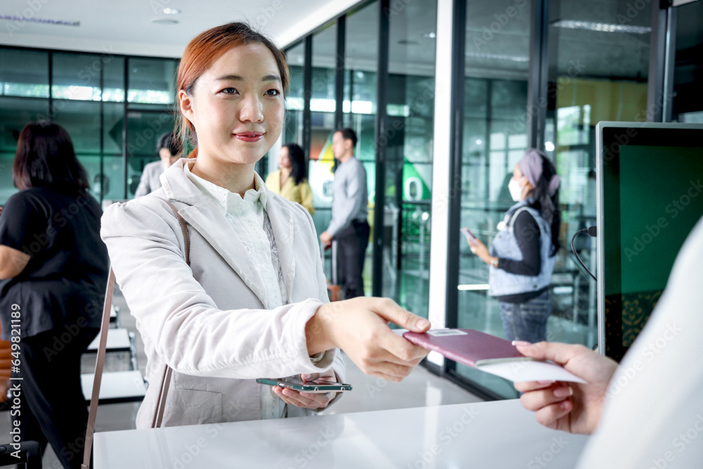 Beautiful Asian female traveler gives passport boarding pass to ...