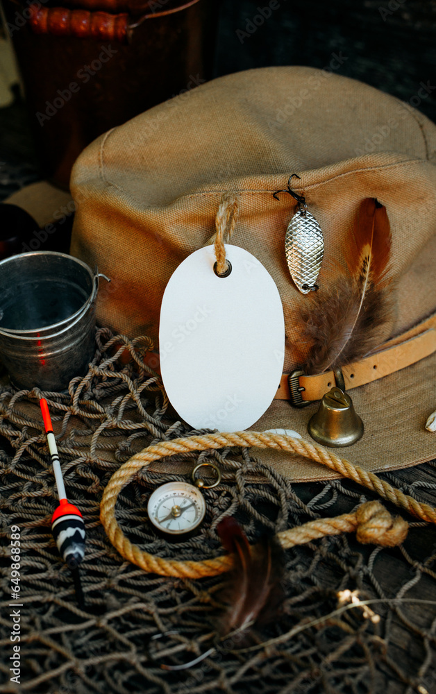 Fishing theme. Oval label on fisher cap with hooks, bucket, fishing ...