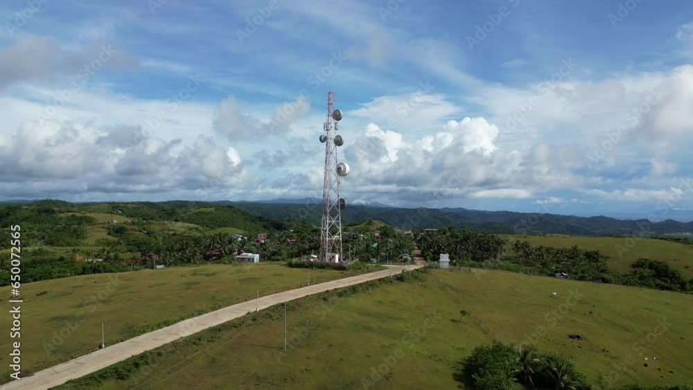 Stunning drone shot approaching a satellite tower next to tropical ...