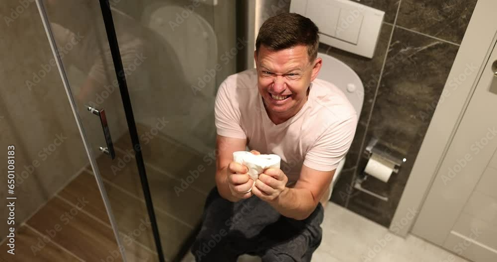Man suffers from diarrhea sitting on toilet at home. Hemorrhoid ...