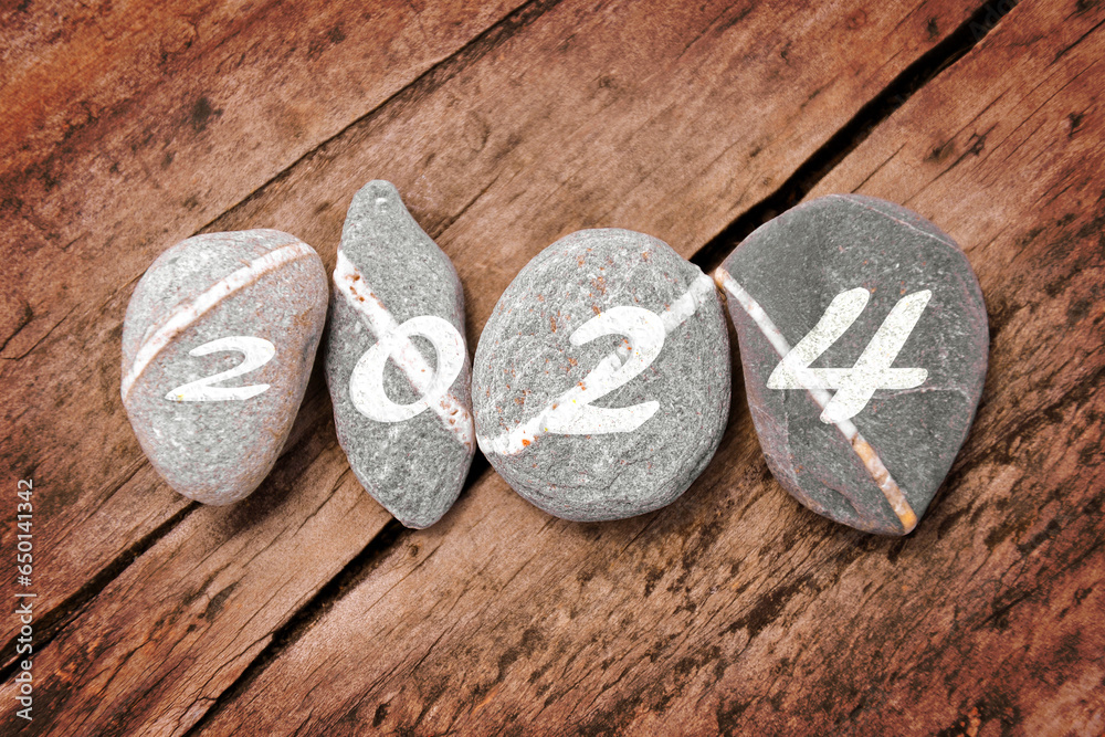 2024 written on a lign of stones on a wooden background Stock 写真 ...