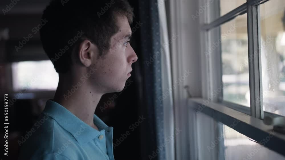 Cinematic shot of a sad young teenage boy, high school aged young man ...