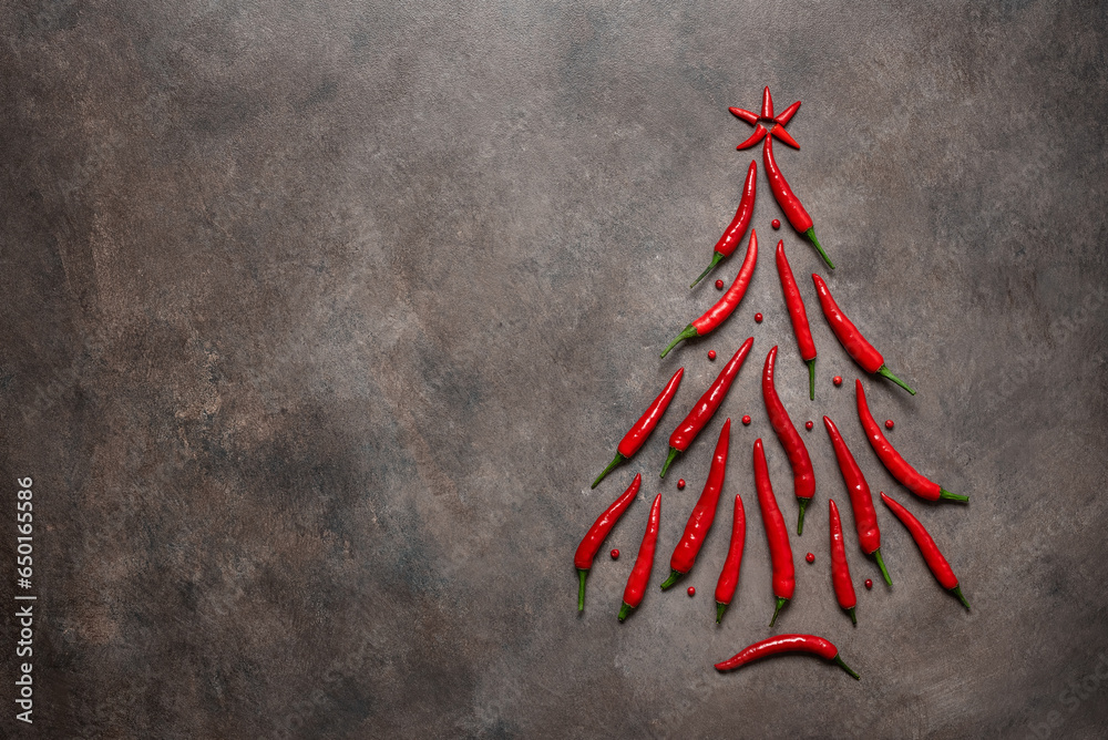 Chili pepper in the shape of a Christmas tree on a brown dark ...