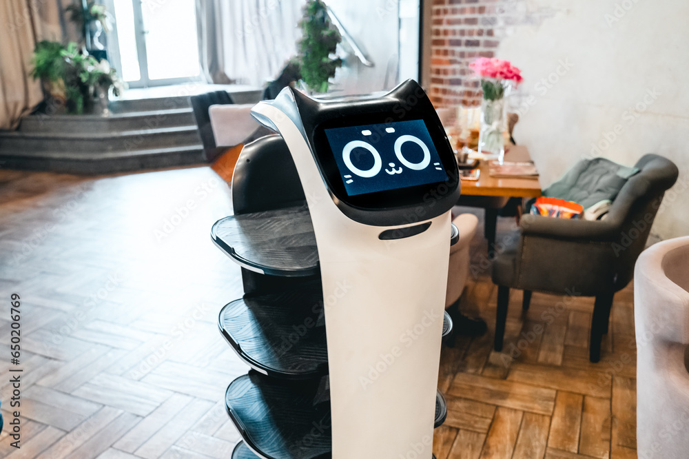 Robot waiter serve food at modern restaurant table.Offering innovation ...