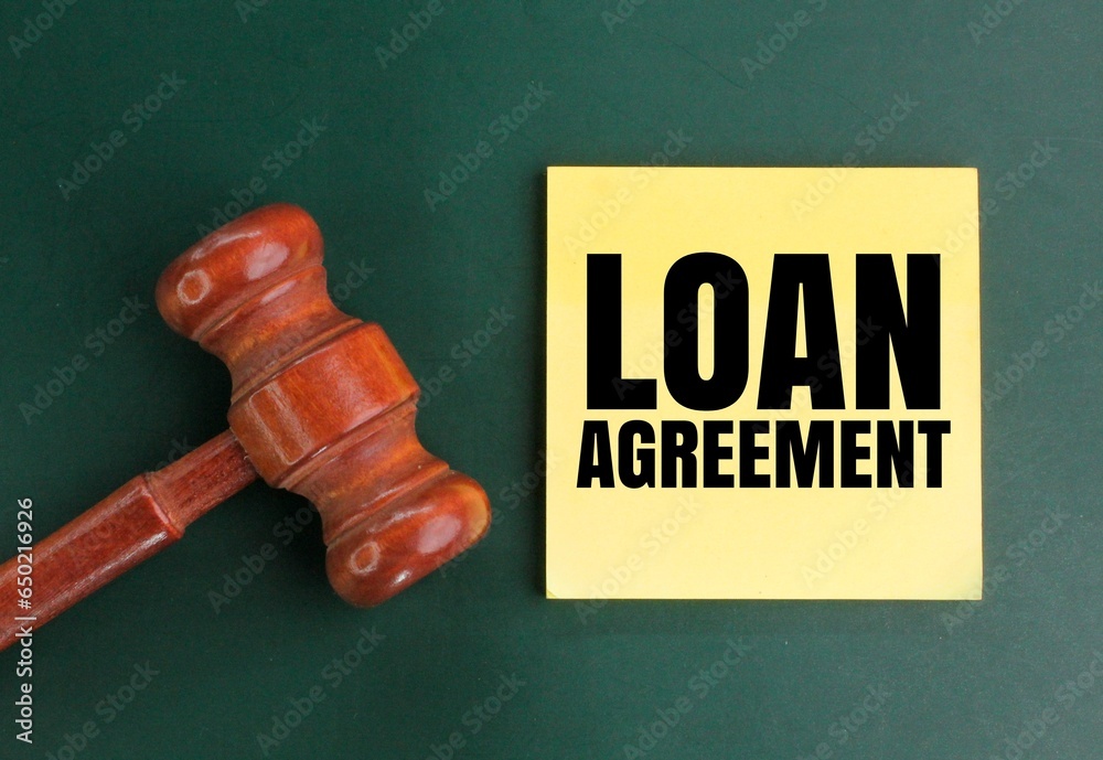 judge's hammer and colored paper with the word loan agreement. loan ...