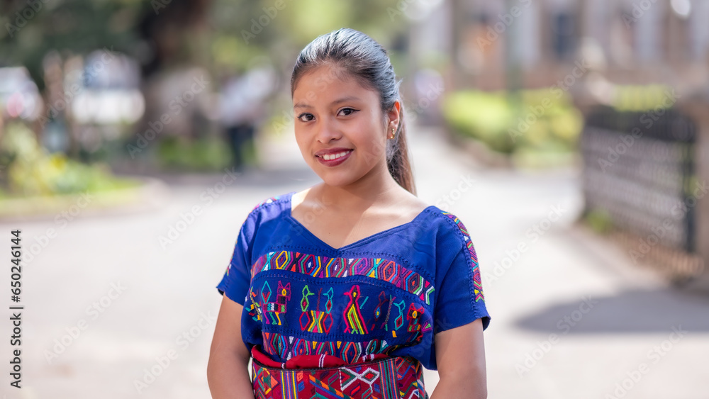 Beautiful Mayan woman shows off her blue dress in the central park of ...
