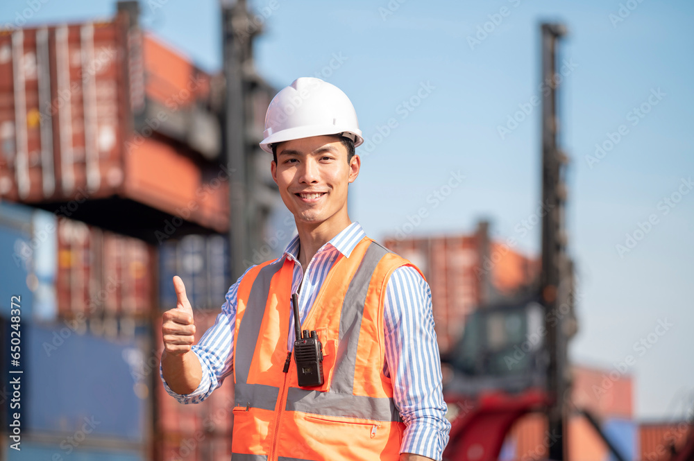 Asian dock control stand on and Pointing up around Shipping container ...