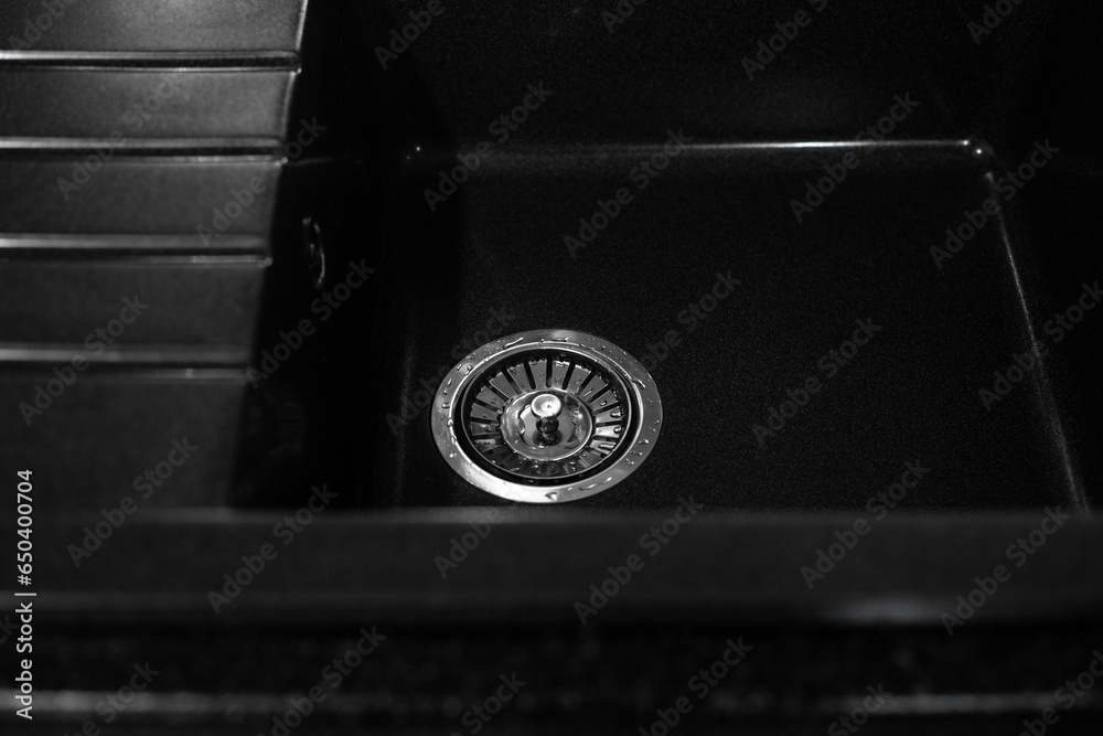 Black square kitchen deep sink with metal drain. Home interior. Stock ...