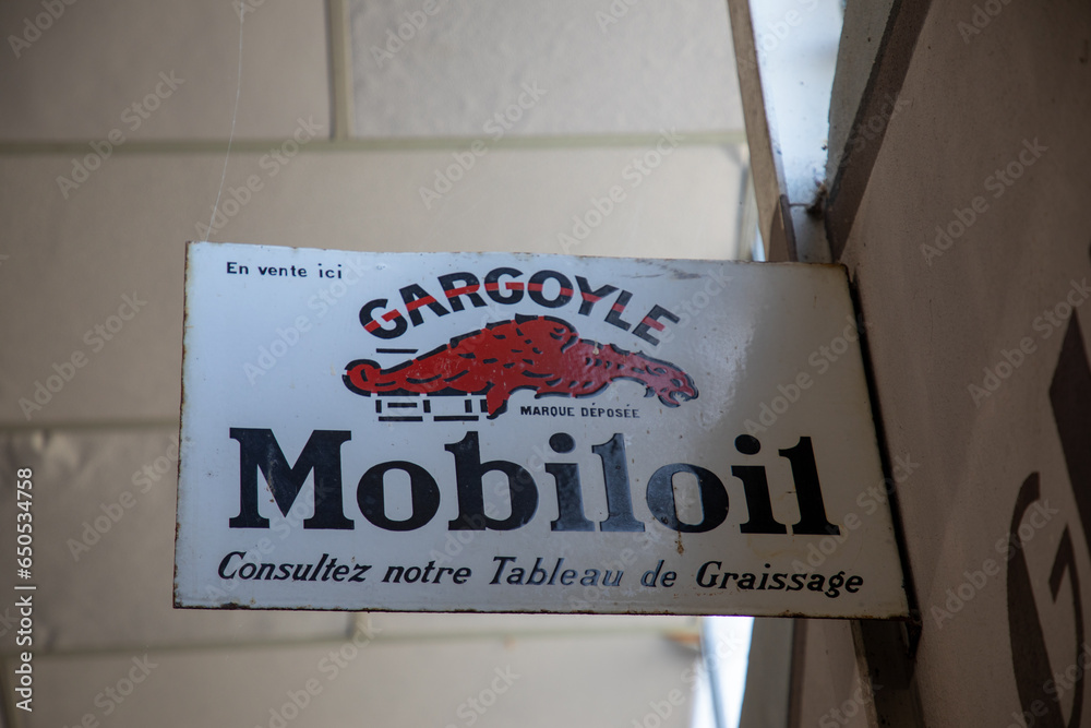 MobilOil Gas Station gargoyle sign text and brand logo on wall facade ...