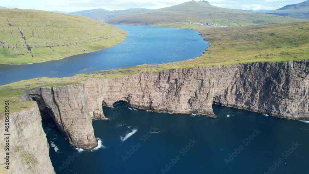 Lake Sorvagsvatn above the Atlantic Ocean, cliff optical illusion. Lake ...