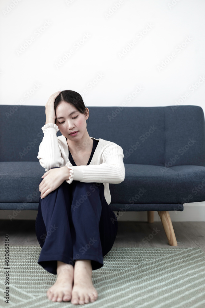 Female having depression sitting alone on sofa. woman headache unhappy ...