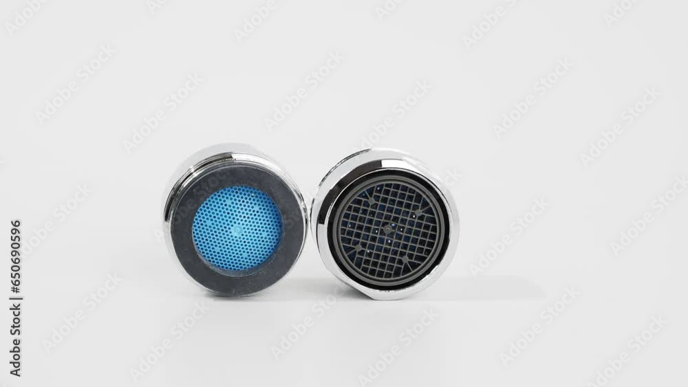 A clean new faucet aerator rotates on a white background. Water tap ...