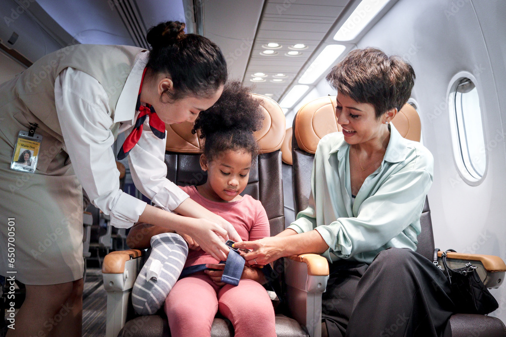 Friendly air hostess take care kid passenger on airplane, flight ...