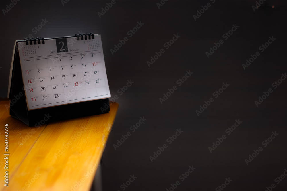 Blurred calendar page in planning concept.Black background. For ...