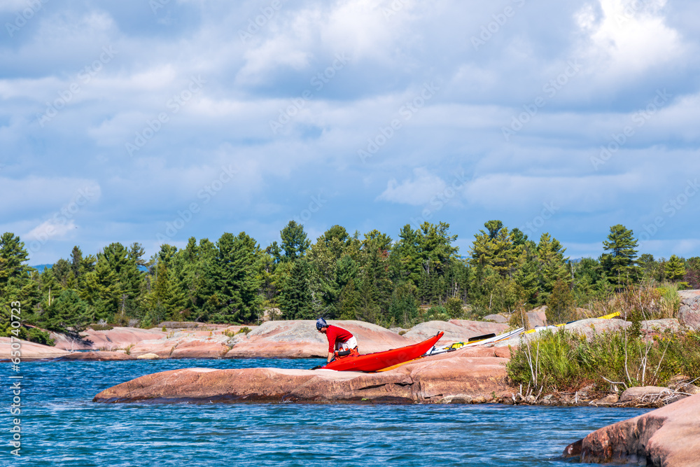 Georgian Bay Sea kayaking: young man in red jacket and blue head wrap ...