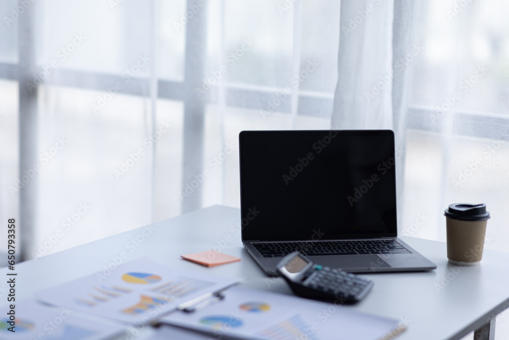 Laptop Computer, notebook, and eyeglasses sitting on a desk in a large ...