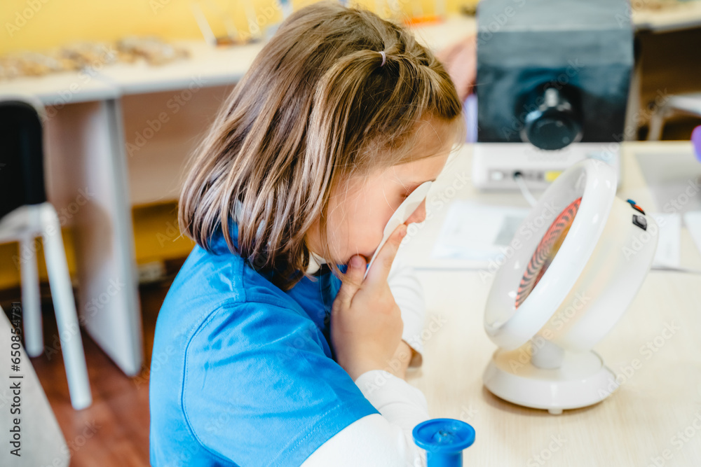 Little girl in medical office undergoing advanced laser vision ...