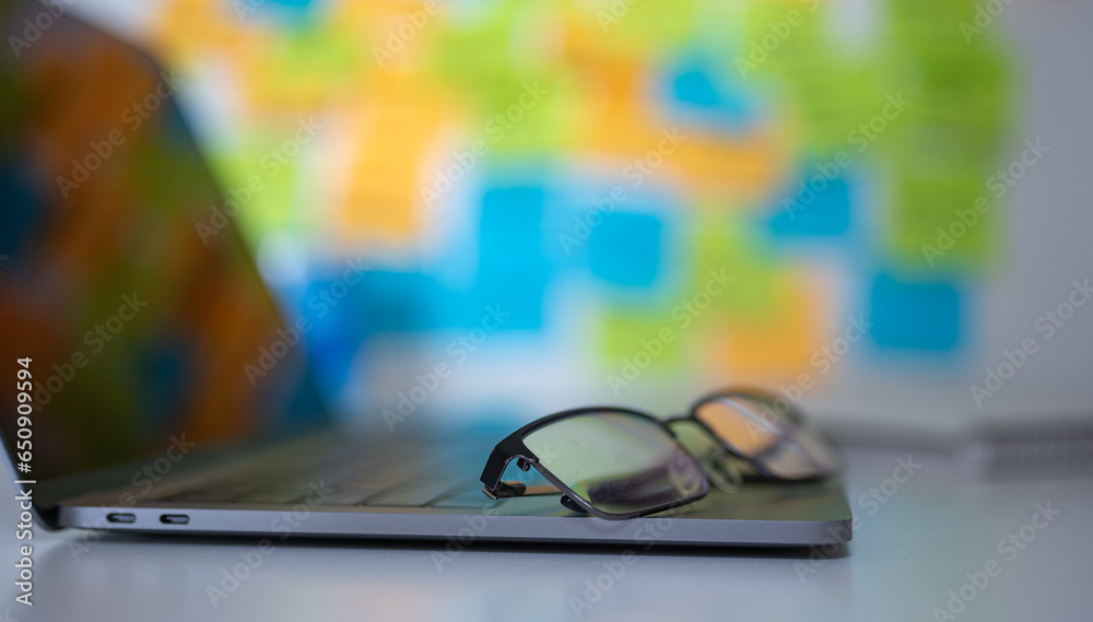 blurred colorful post note background with computer notebook and ...