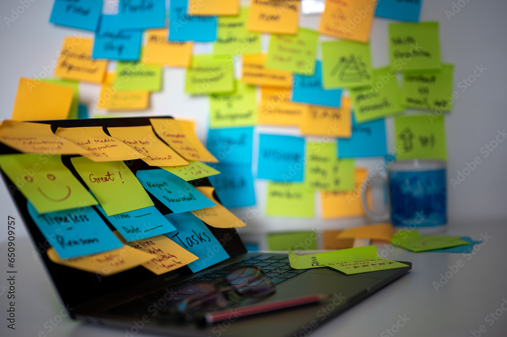 blurred colorful post note background with computer notebook and ...