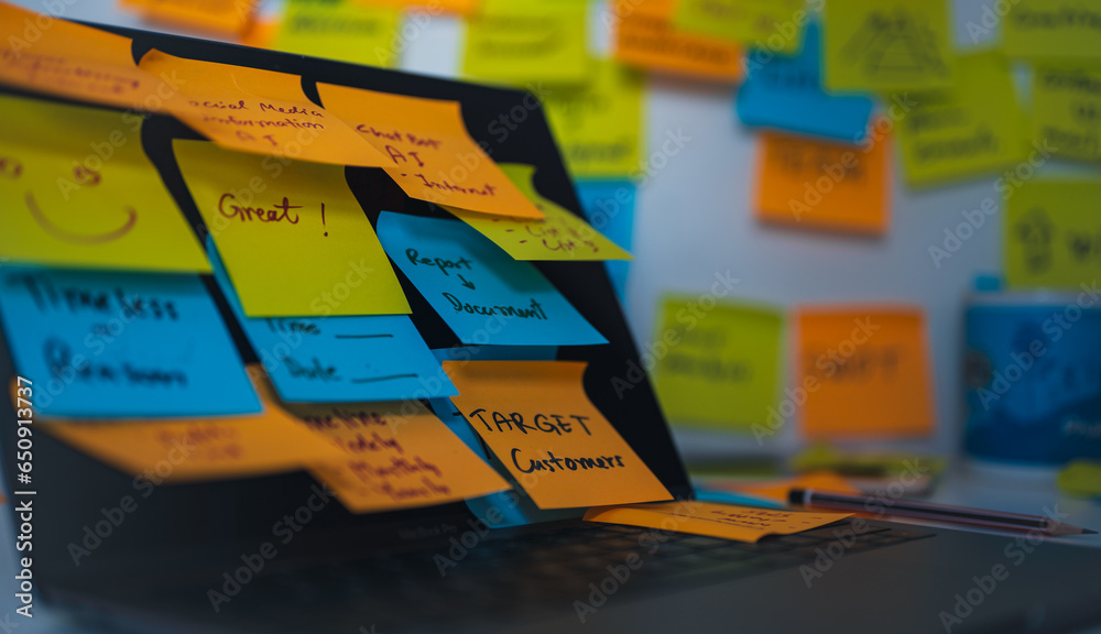 blurred colorful post note background with computer notebook , concept ...