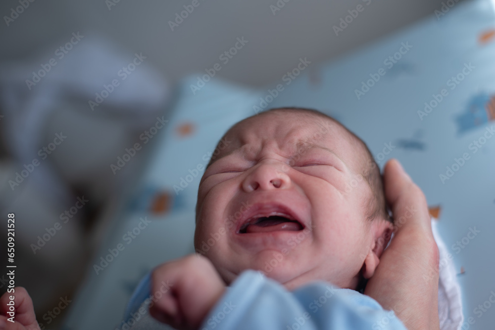 newborn crying during diaper change Stock Photo | Adobe Stock