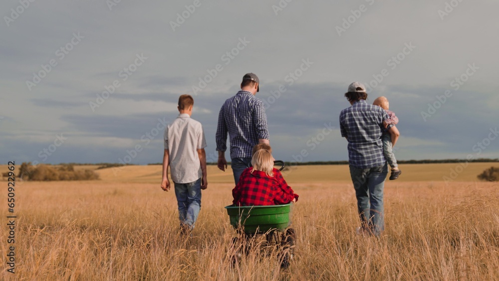 Happy farmer family with different age children play in country field ...