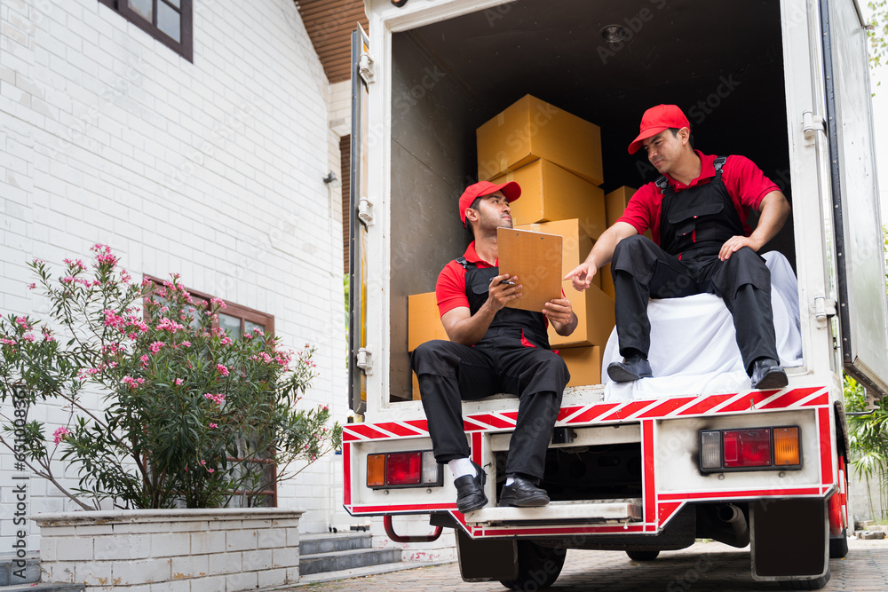 Two professional delivery staffs dressed shipping company uniform ...