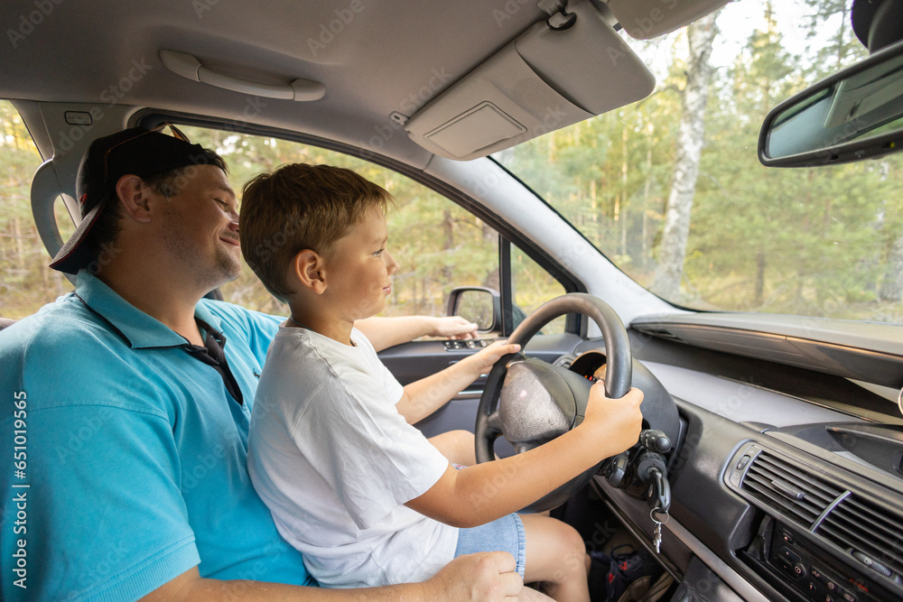 Father and son happily spend time together. A father teaches a small ...