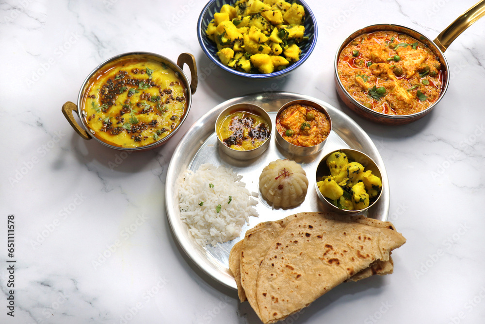 Indian vegetarian Thali or platter includes Aloo ki sabji, dal rice ...