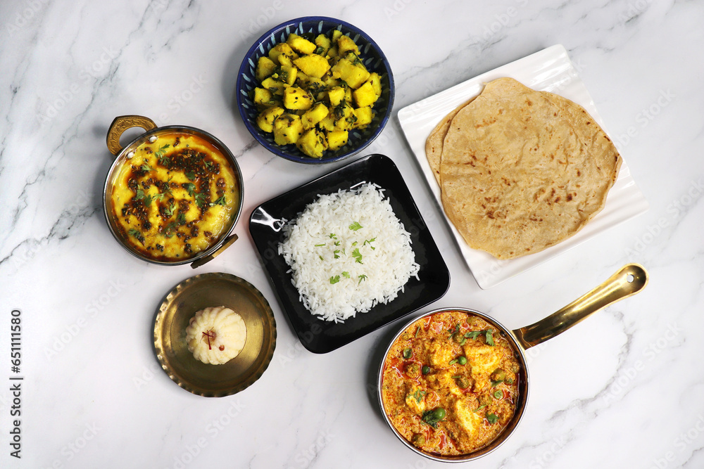 Indian vegetarian Thali or platter includes Aloo ki sabji, dal rice ...