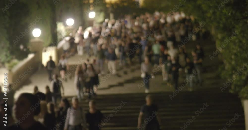 Unfocused shot of people ascending a staircase, rendering them ...