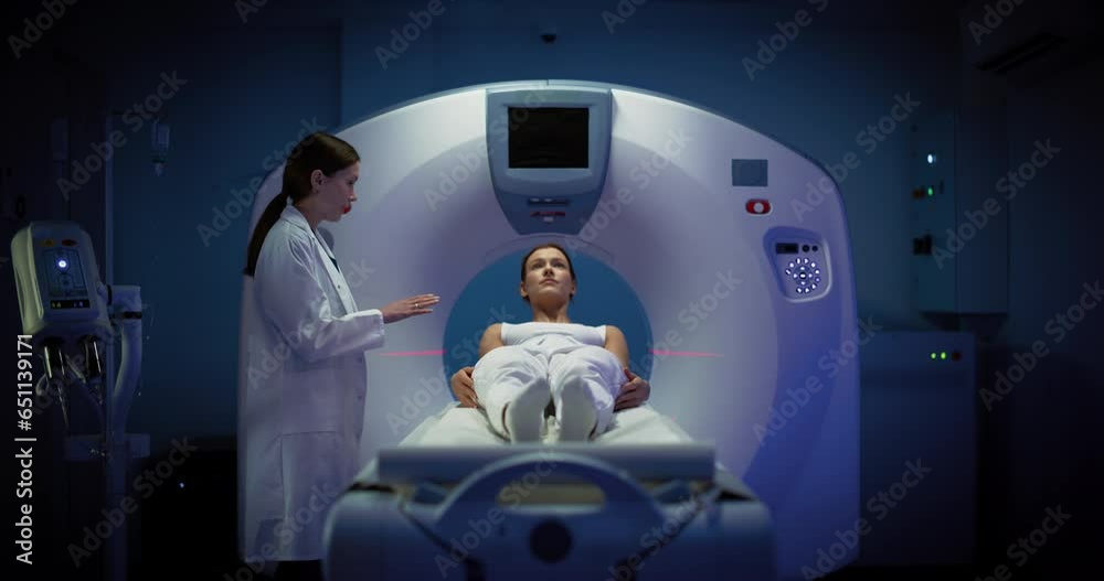 Medium Shot of a Female Patient Lying on a CT or MRI Scan Bed While it ...