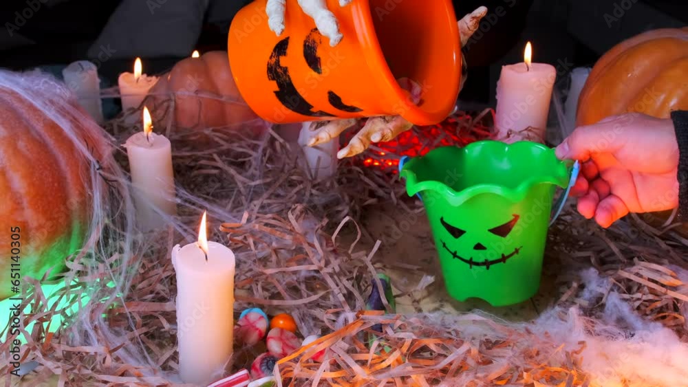Vidéo Stock Creepy skeleton costume hands and sweets buckets on spirit ...