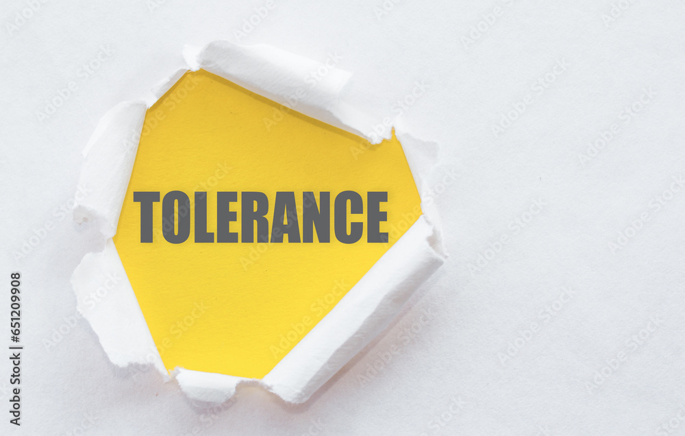 Tolerance text on a yellow background under white torn paper. Equality ...