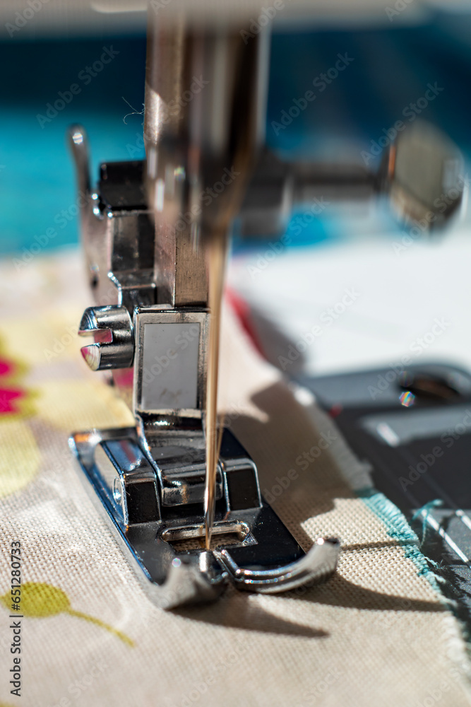Sewing machine foot in close up. Selective focus on the tip of the ...
