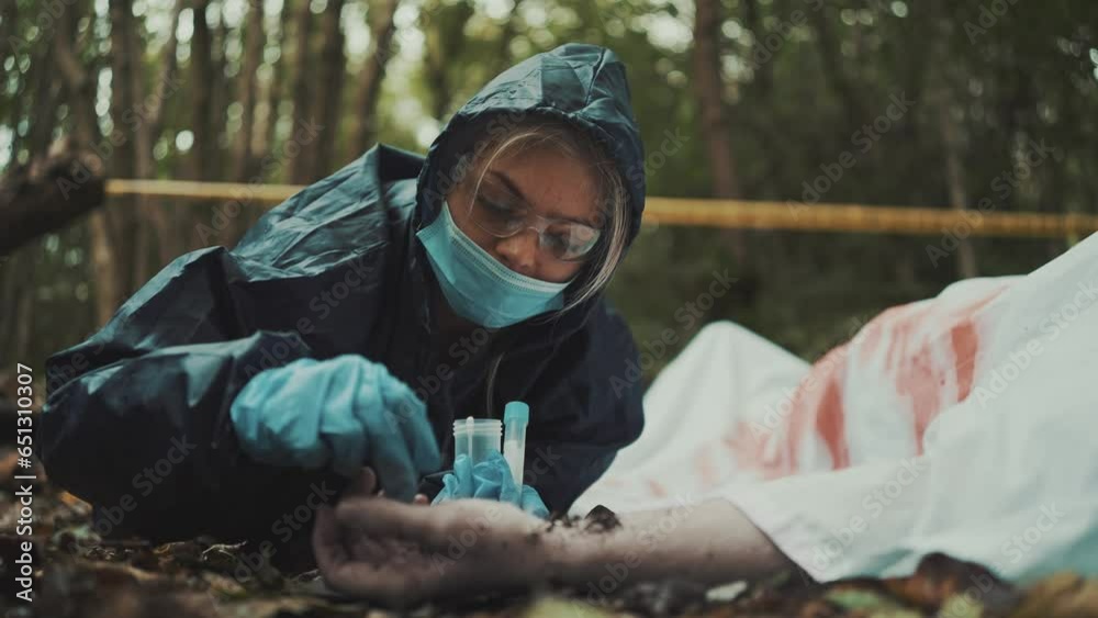 Coroner ispecting a dead body and taking dna samples from a Crime Scene ...
