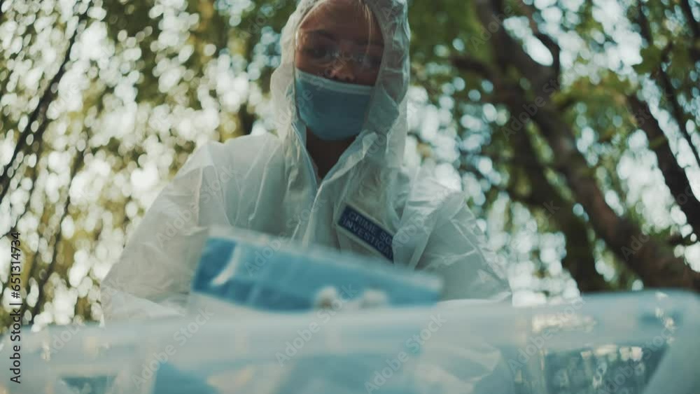 Woman forensic police investigator putting a human's bone on the crime ...