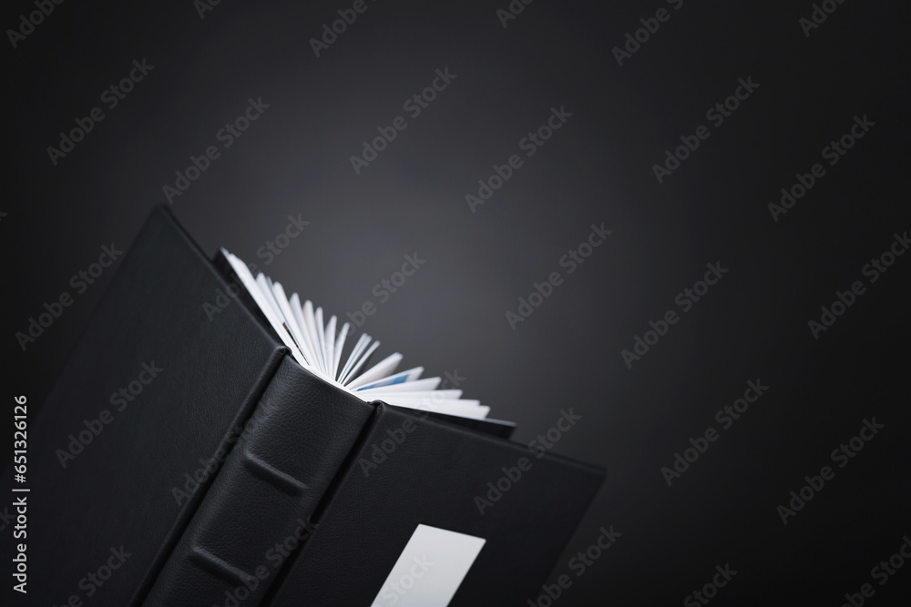 A beautiful leather bound books against a black background. Wedding ...