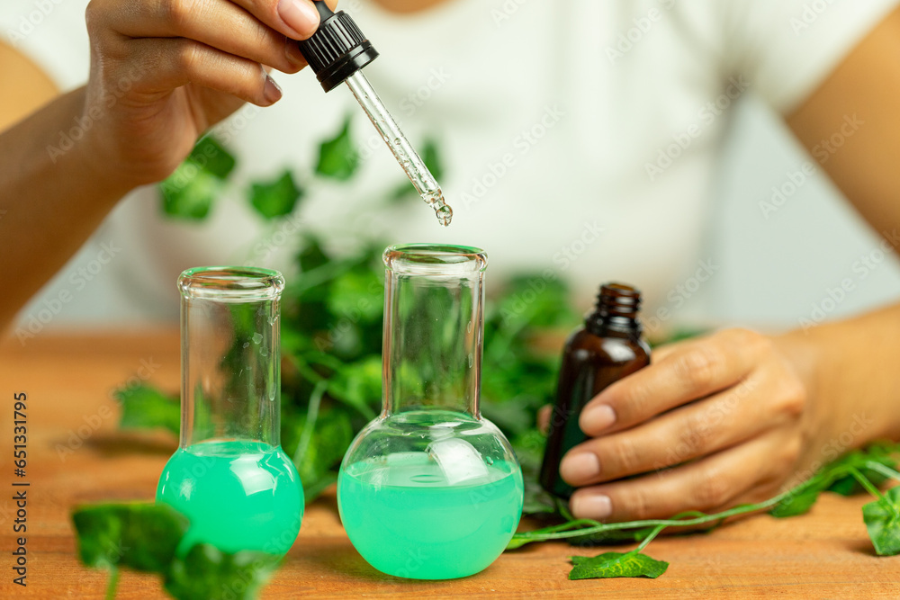 Glass vials for scientific research, green liquid, bottle with pipette ...