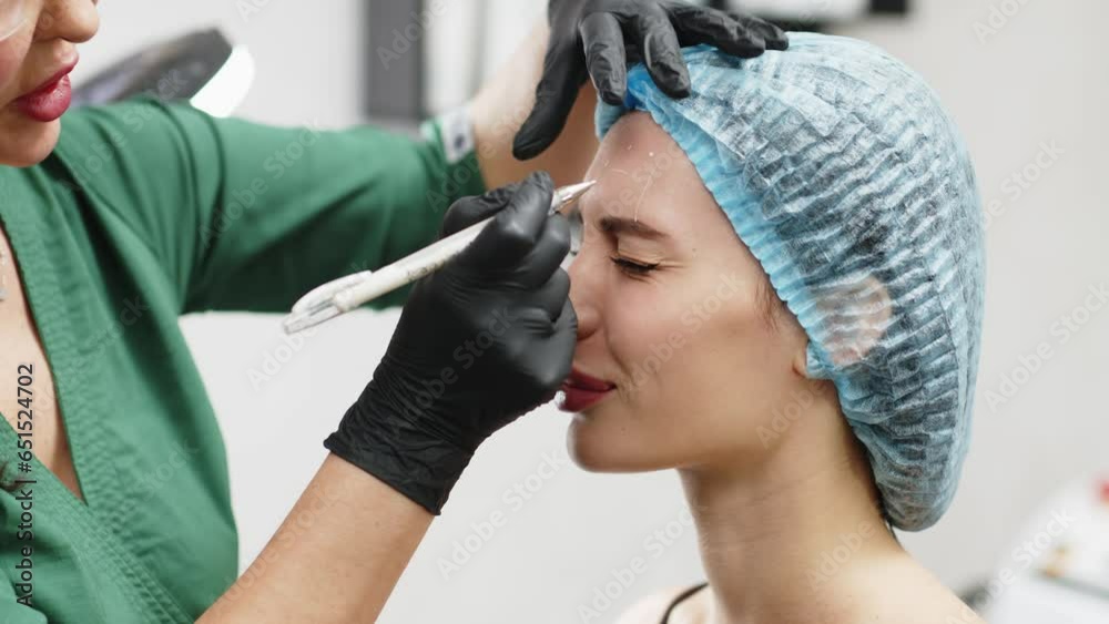 Medical office, a female doctor photographs the patient’s face on the ...