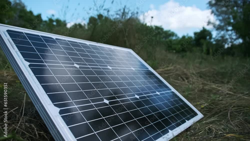 Portable solar panel lie on the ground in nature outdoors close-up ...