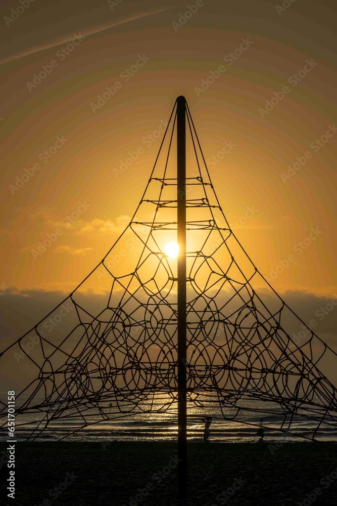 sunrise on the beach at Malvarosa with a pyramid string structure at ...