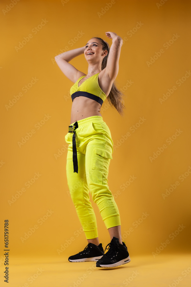 Beautiful girl in yellow outfit dancing zumba. Happy dance instructor ...