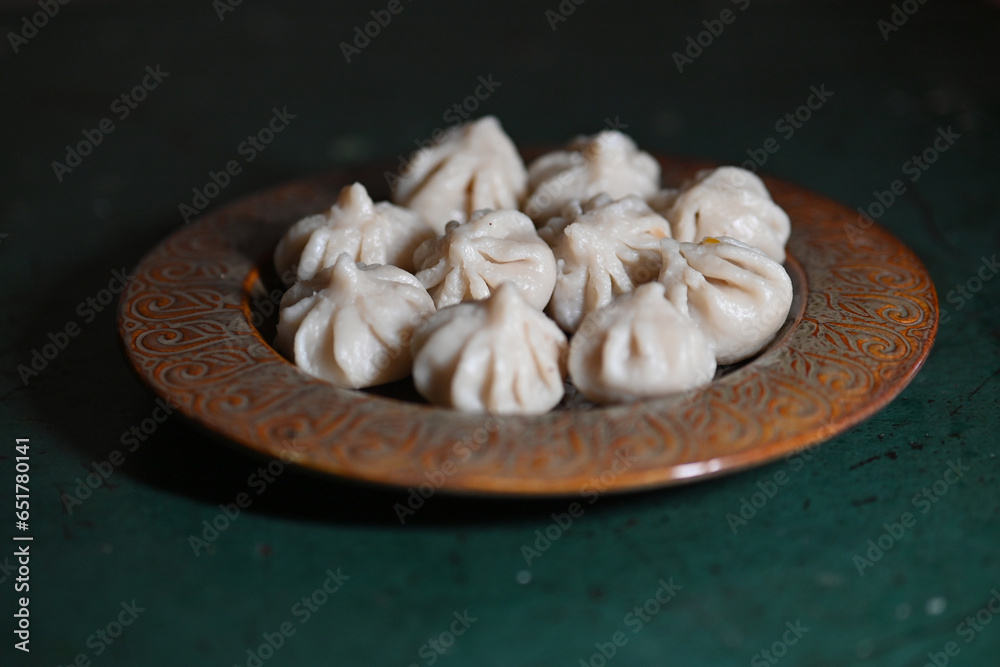 Plate with fresh white steamed Modak. Favorite sweets of the Lord ...
